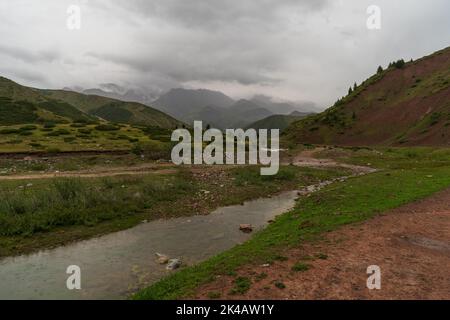 River flowing through the green Karkyra Valley between Kazakhstan and ...