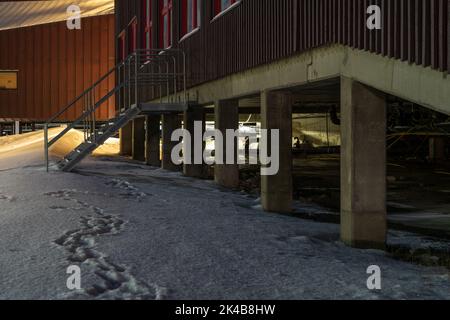 Svalbard University Science Centre at night on raised stilts permafrost ...