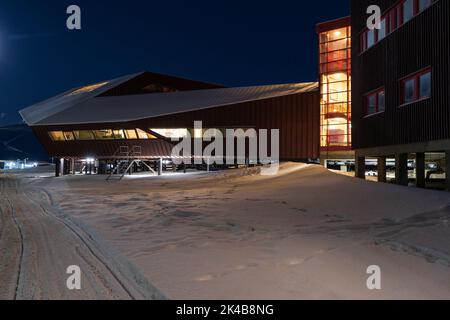 Svalbard University Science Centre at night on raised stilts permafrost ...
