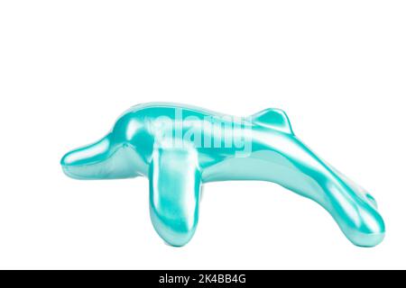 A stylized turquoise dolphin figurine. Isolated over white background ...