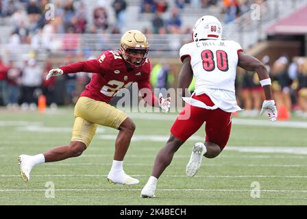 Louisville wide receiver Chris Bell, left, runs from Boston College ...