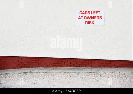Car park users do so at own risk sign Stock Photo - Alamy
