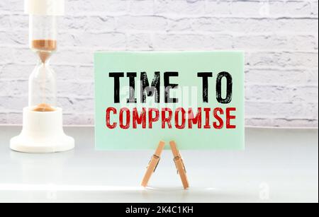 businesman hold notepad with text Time to compromise. White background ...