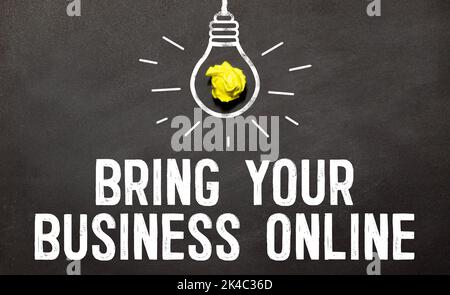 bring your business online. text on white paper on wood background near ...