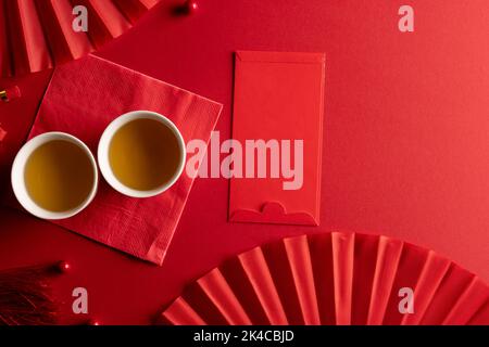 Composition of traditional chinese fan and decorations on red ...