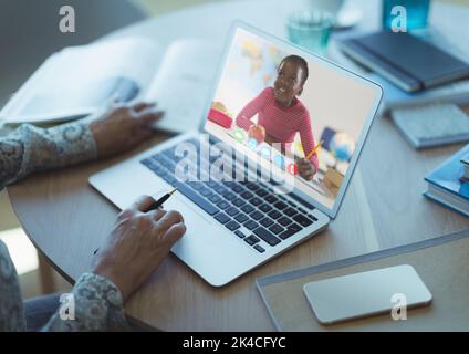 African american schoolgirl learning displayed on laptop screen placed ...