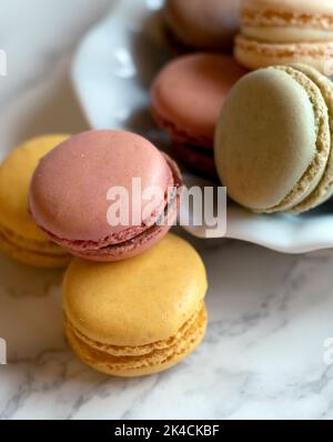 Still life of crispy meringue macarons filled with luscious creamy ...