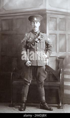 WW1 British Army sergeant standing stoically in a flooded trench in ...