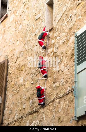 Climbing red santa claus on ladder agains white brick wall Stock Photo ...