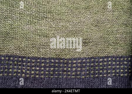 Details of green and dark grey woollen hand knitted sweater with ...