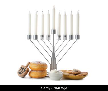 Menorah with candles, delicious food and dreidels for Hanukkah ...