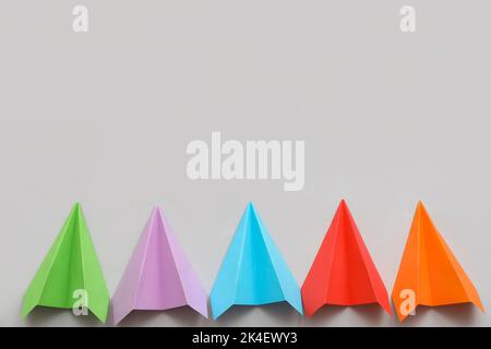 Colorful paper planes on grey background Stock Photo - Alamy