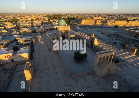 Sunrise view of roof-top vaults of Kalan Mosque and Mir-i-Arab Madrasa, Kalon Minaret Tower ...