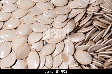 Pumpkin seeds creating a natural, spiral structure. Pure pumpkin seeds ...