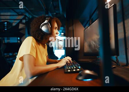 Young curly woman playing cyber games Stock Photo - Alamy