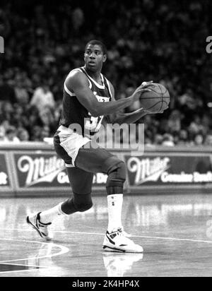 NBA superstar Ervin "Magic" Johnson shoots a free throw during game ...