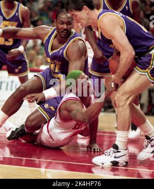Dennis Rodman of the Chicago Bulls dives for a ball grabbed by Utah ...
