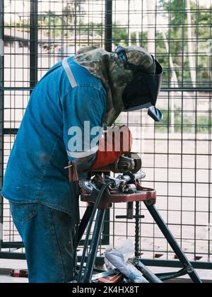 Iron soldering, Man working on iron soldering, welding sparks, men ...