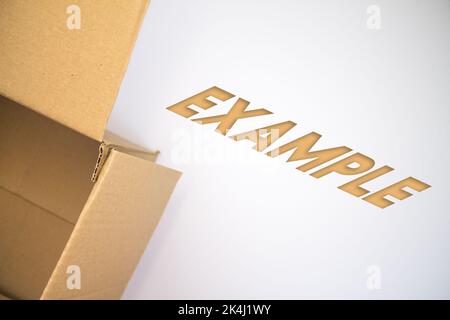 Example word with cardboard box. Brown folded card box Stock Photo - Alamy