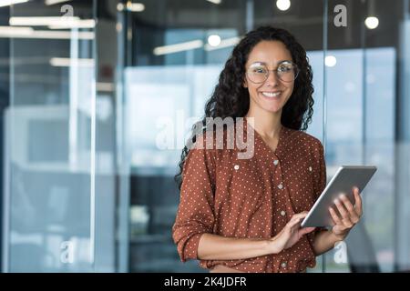 Young hispanic woman holding reporter microphone doing ok sign with ...