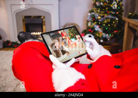 Santa claus making tablet christmas video call with smiling caucasian ...