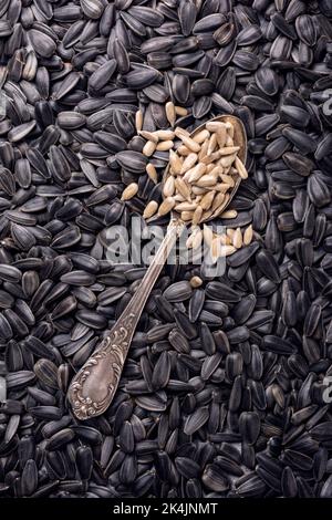 Unpeeled sunflower seeds as background Stock Photo - Alamy
