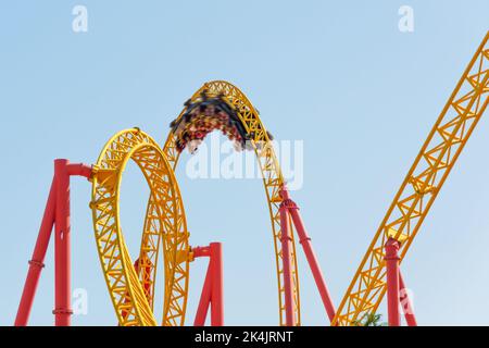 Amusement cart makes circular loops upside down and turns sharply out ...