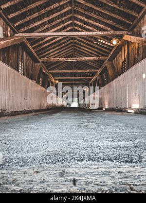 Vertical shot of a wooden bridge covered in snow in the Black Forest ...