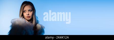 pierced young woman with winter makeup and white eyebrows posing with ...