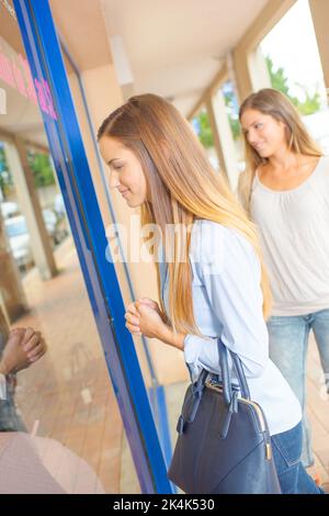 Two friends doing some window shopping Stock Photo - Alamy