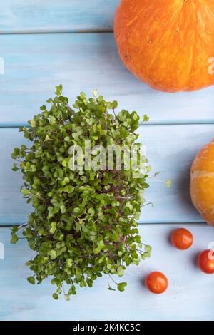 Microgreen sprouts of kohlrabi cabbage with pumpkin on blue wooden ...
