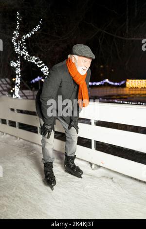 Smiling man in sweater and skates hugging african american girlfriend ...