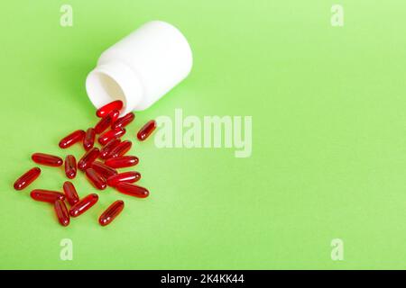 Red pills spilled around a pill bottle. Medicines and prescription ...