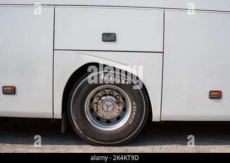 Huge bus wheel with a shiny disc. White bus wheel arch. Michelin tire ...