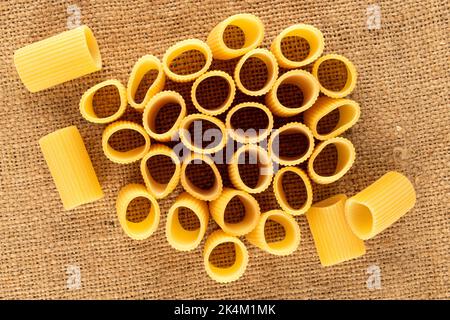 Several raw yellow cannelloni on a jute cloth, macro, top view Stock ...