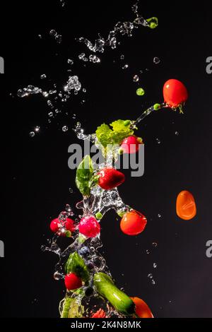 Some strawberries thrown in water with black and white background Stock ...