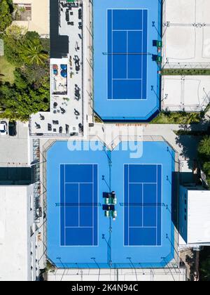 Aerial photo of blue tennis courts with white lines and light blue ...