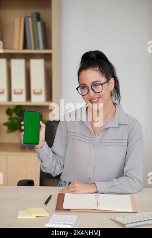 Young elegant businesswoman making presentation to colleagues in modern ...