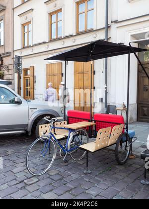 Krakow, Poland - August 4, 2018: ornamental bicycle with table and ...