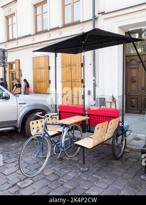 Krakow, Poland - August 4, 2018: ornamental bicycle with table and ...