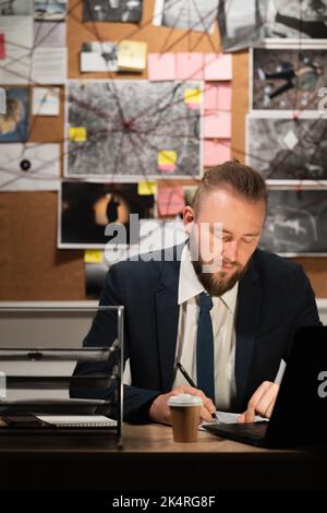 Police investigator searching crime case file in records storage. Law ...