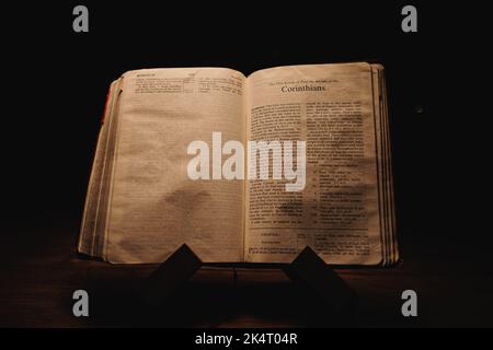 A closeup shot of a historic old Bible open on the Timothy pages on ...