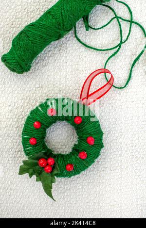 Flat lay. Kids decorating small gingerbread houses at the Christmas ...