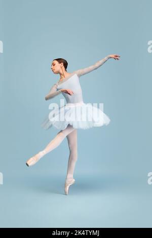 Portrait of flexible woman, graceful ballerina dancing with fabric ...