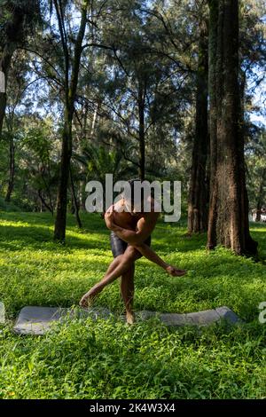 Young hispanic man doing yoga exercise at home Stock Photo - Alamy