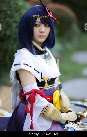 Japanese young woman hunter cosplay with bow on Japanese garden Stock ...