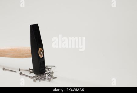 hammer with nails soft green background Stock Photo - Alamy