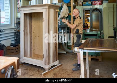 Antique Carpenter In His Workshop Oiling A Walnut Baroque Cabinet Door ...