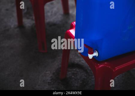 Slim, rectangular space saving blue container with faucet tap contains ...