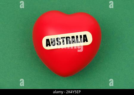 Love to motherland. On a green surface lies a red heart with the ...